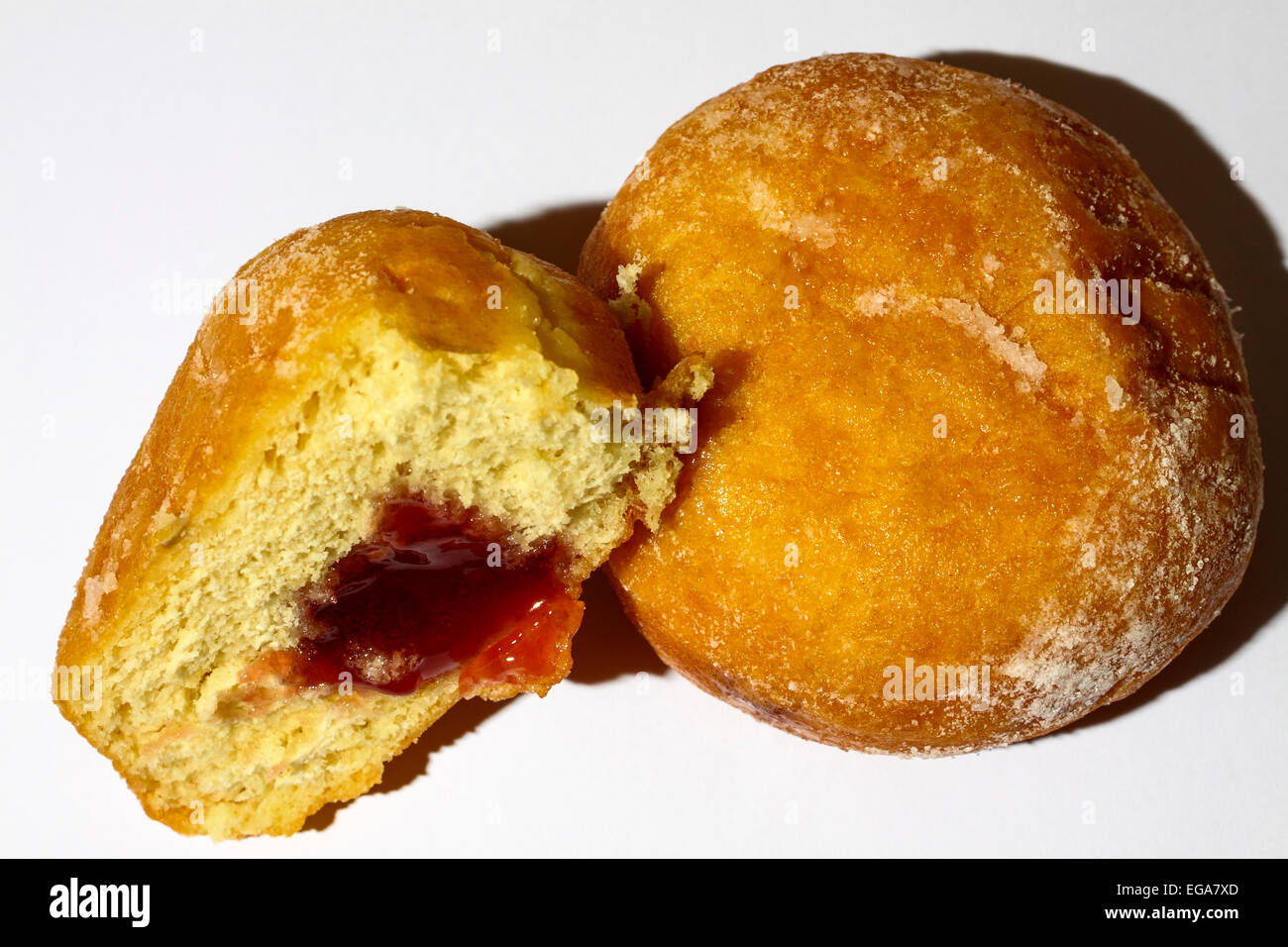 Doughnut sliced in half with jam oozing out Stock Photo - Alamy