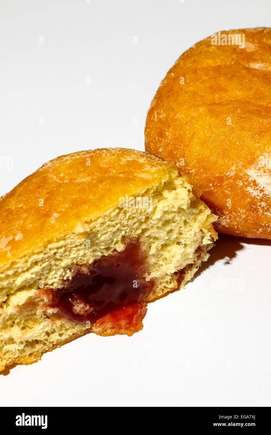 Doughnut sliced in half with jam oozing out Stock Photo - Alamy