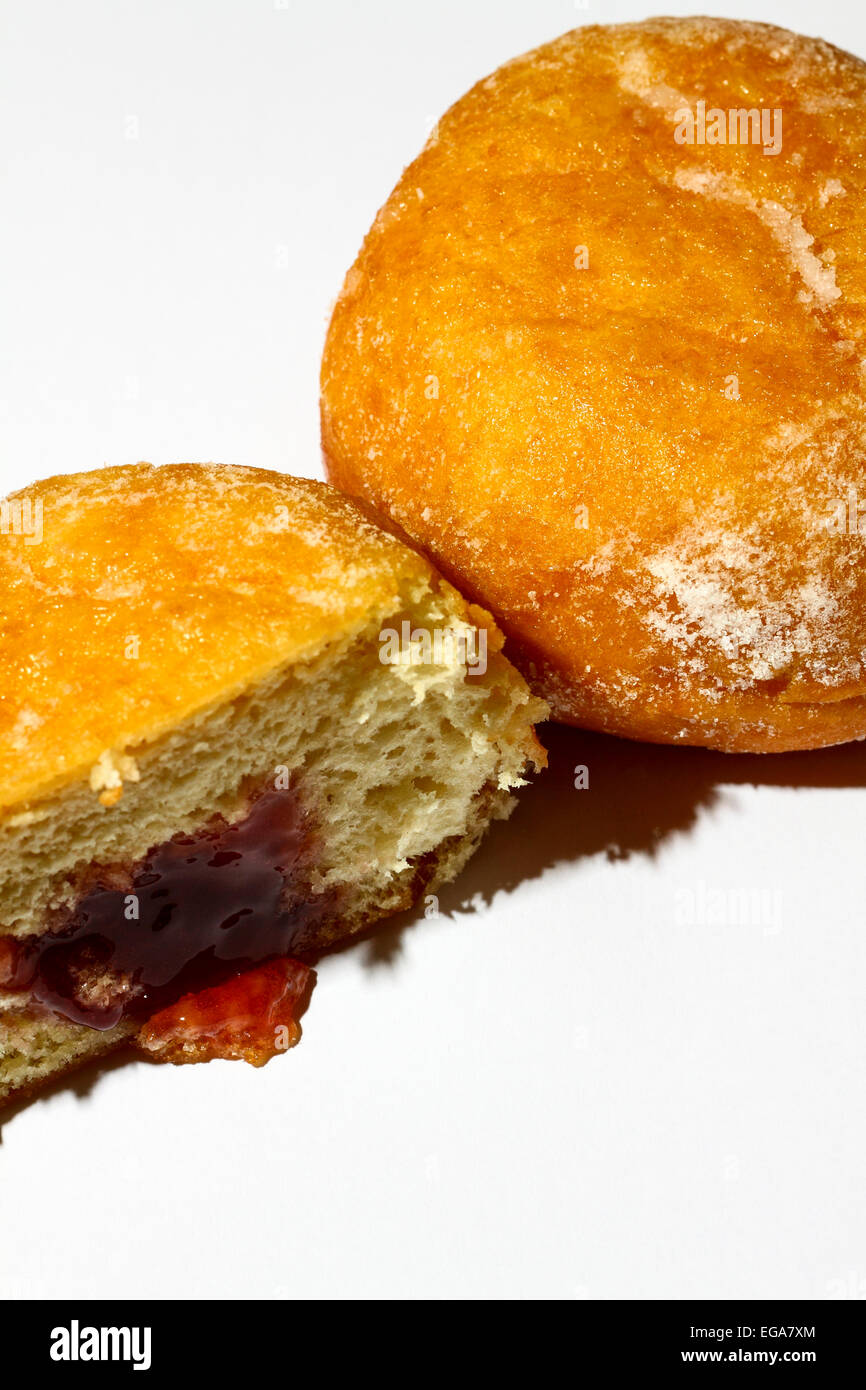 Doughnut sliced in half with jam oozing out Stock Photo - Alamy