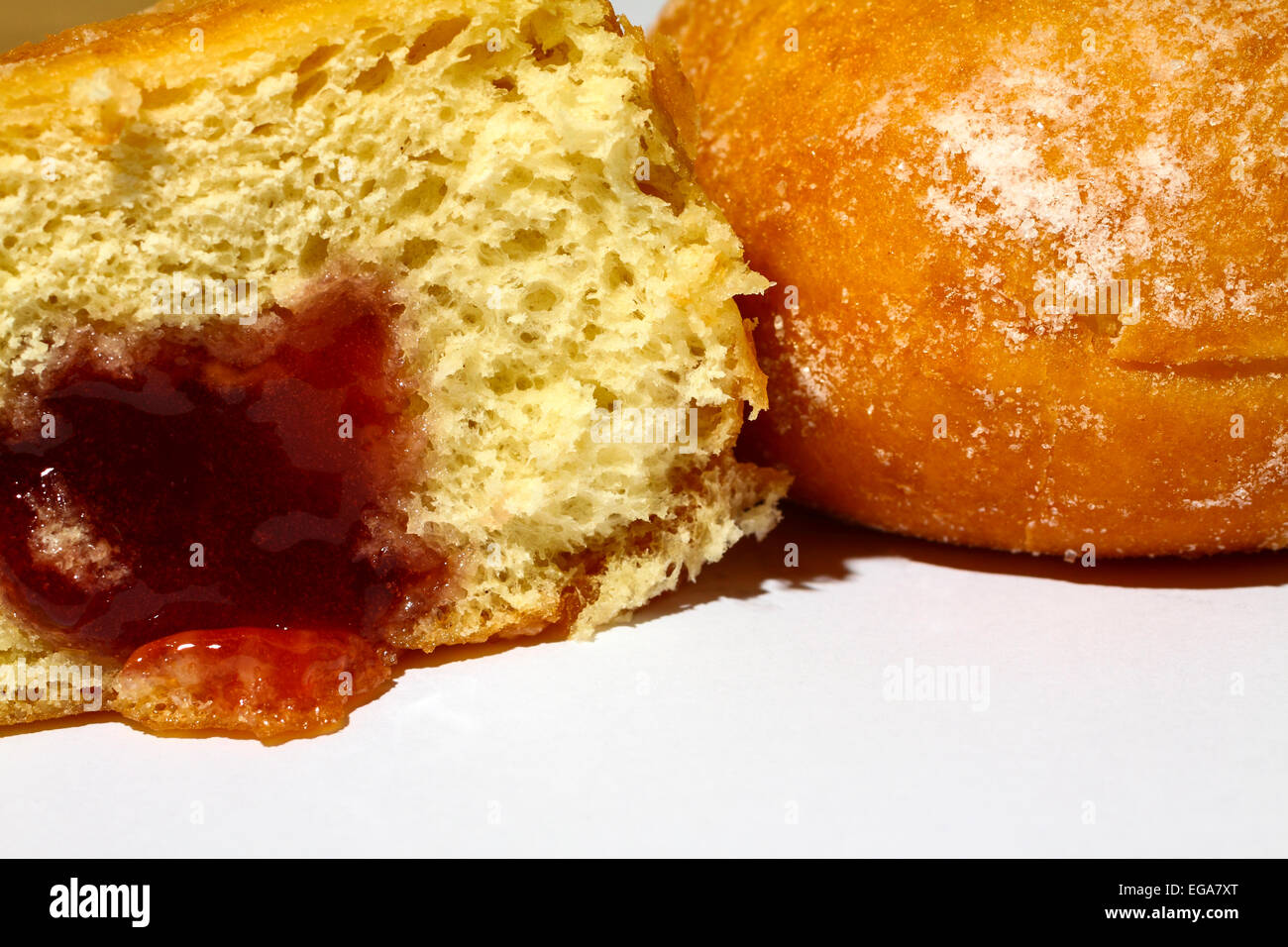 Doughnut sliced in half with jam oozing out Stock Photo - Alamy