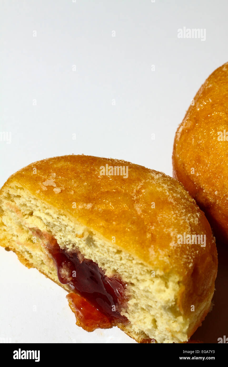 Doughnut sliced in half with jam oozing out Stock Photo - Alamy