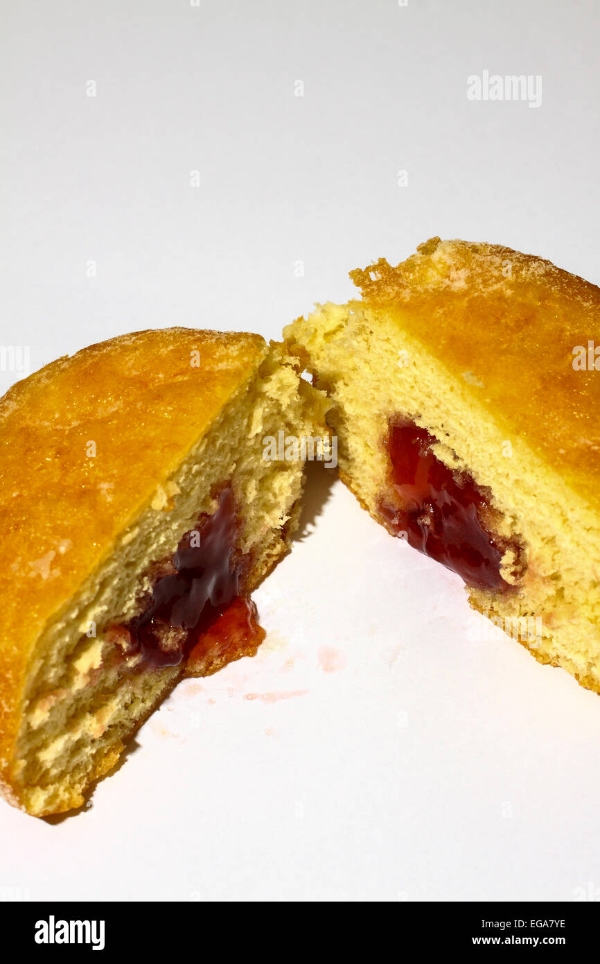 Doughnut sliced in half with jam oozing out Stock Photo - Alamy