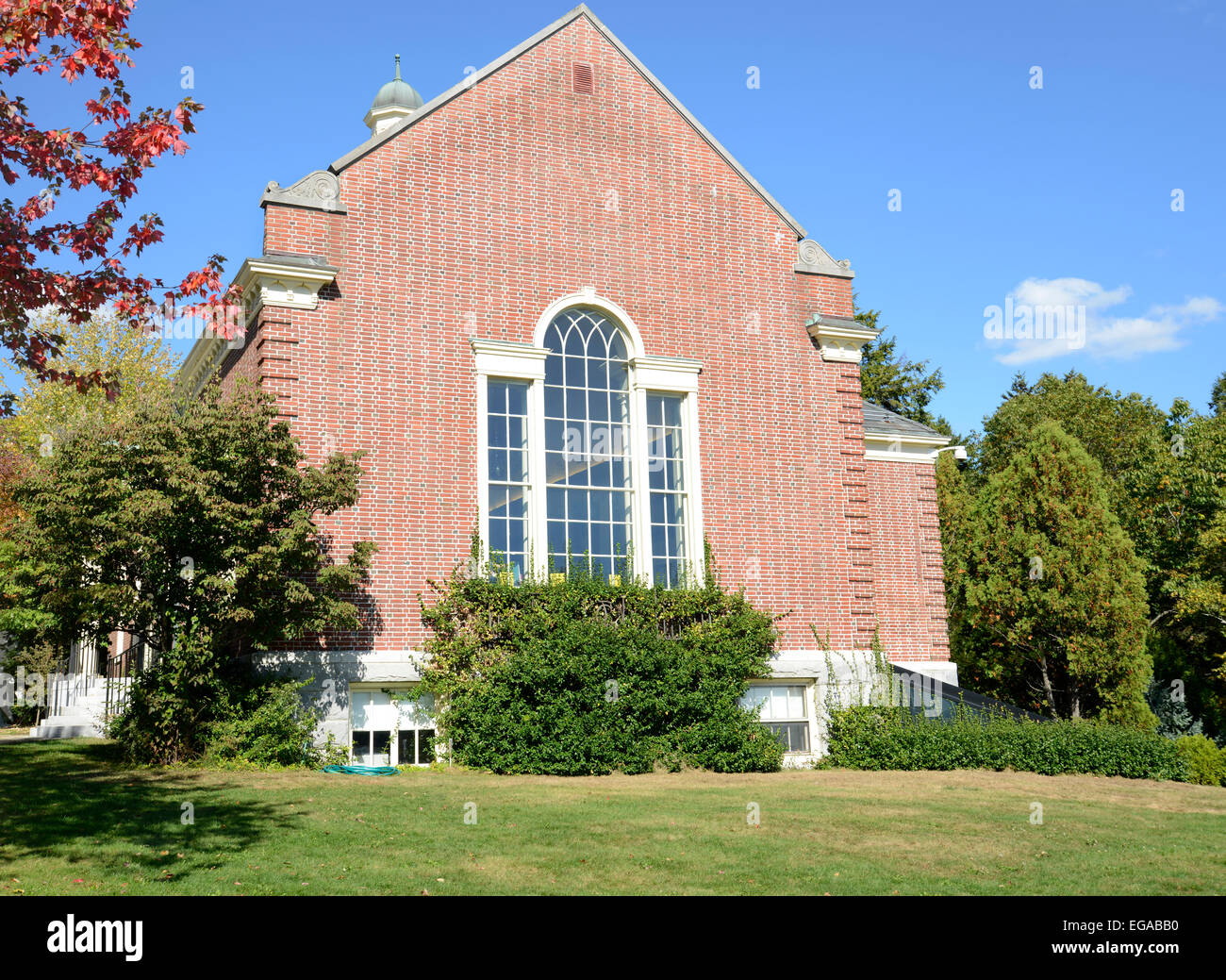 exterior of a red brick colonial style building. there is a large ...
