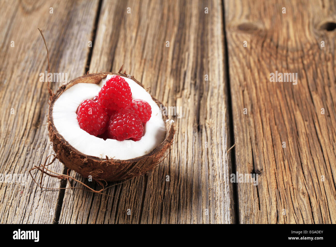 Fresh raspberries in a coconut shell Stock Photo - Alamy