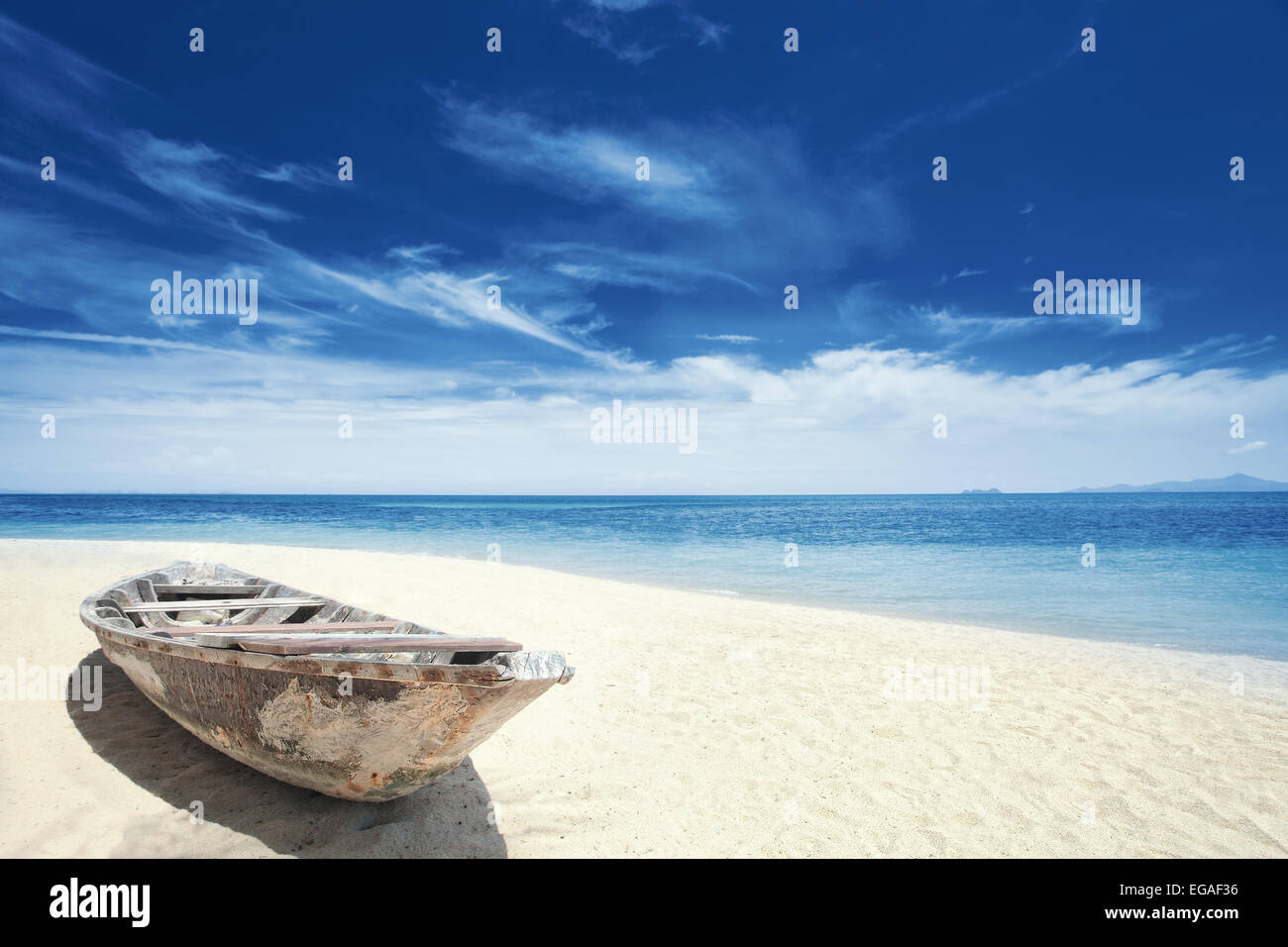 View of nice tropical beach with old boat Stock Photo - Alamy