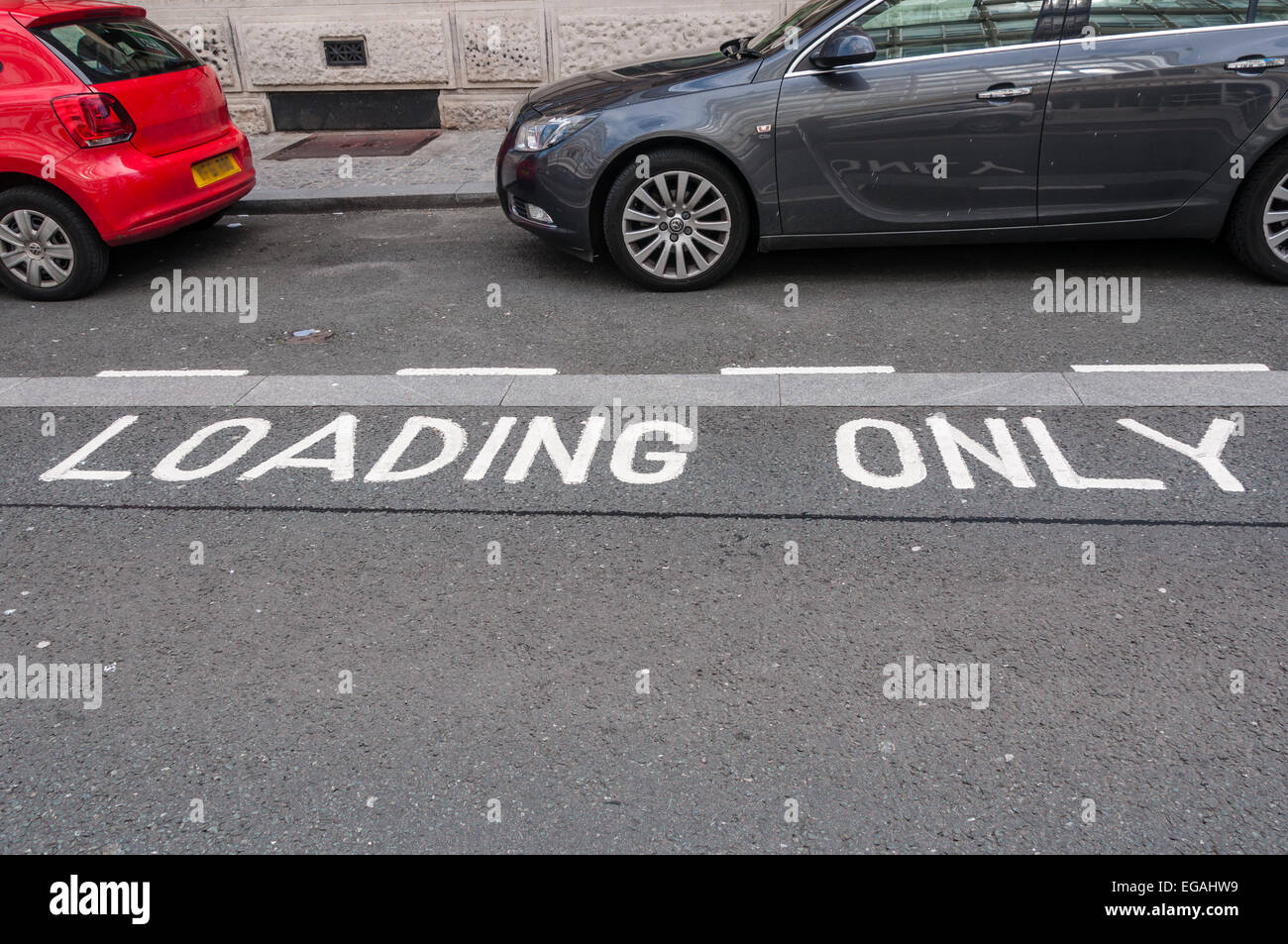 Loading only bay with cars parked in it Stock Photo - Alamy