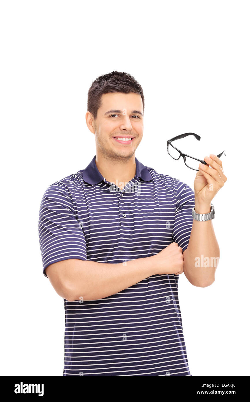 Vertical shot of a young man holding glasses isolated on white ...