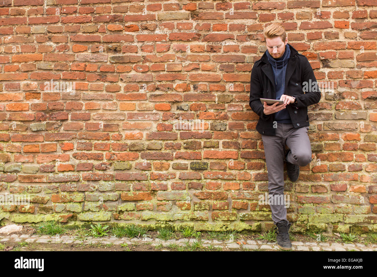Red brick wall man standing hi-res stock photography and images - Alamy
