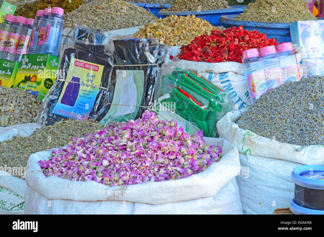 Colourful spice containers and dried flower heads, Marrakech, Morocco ...