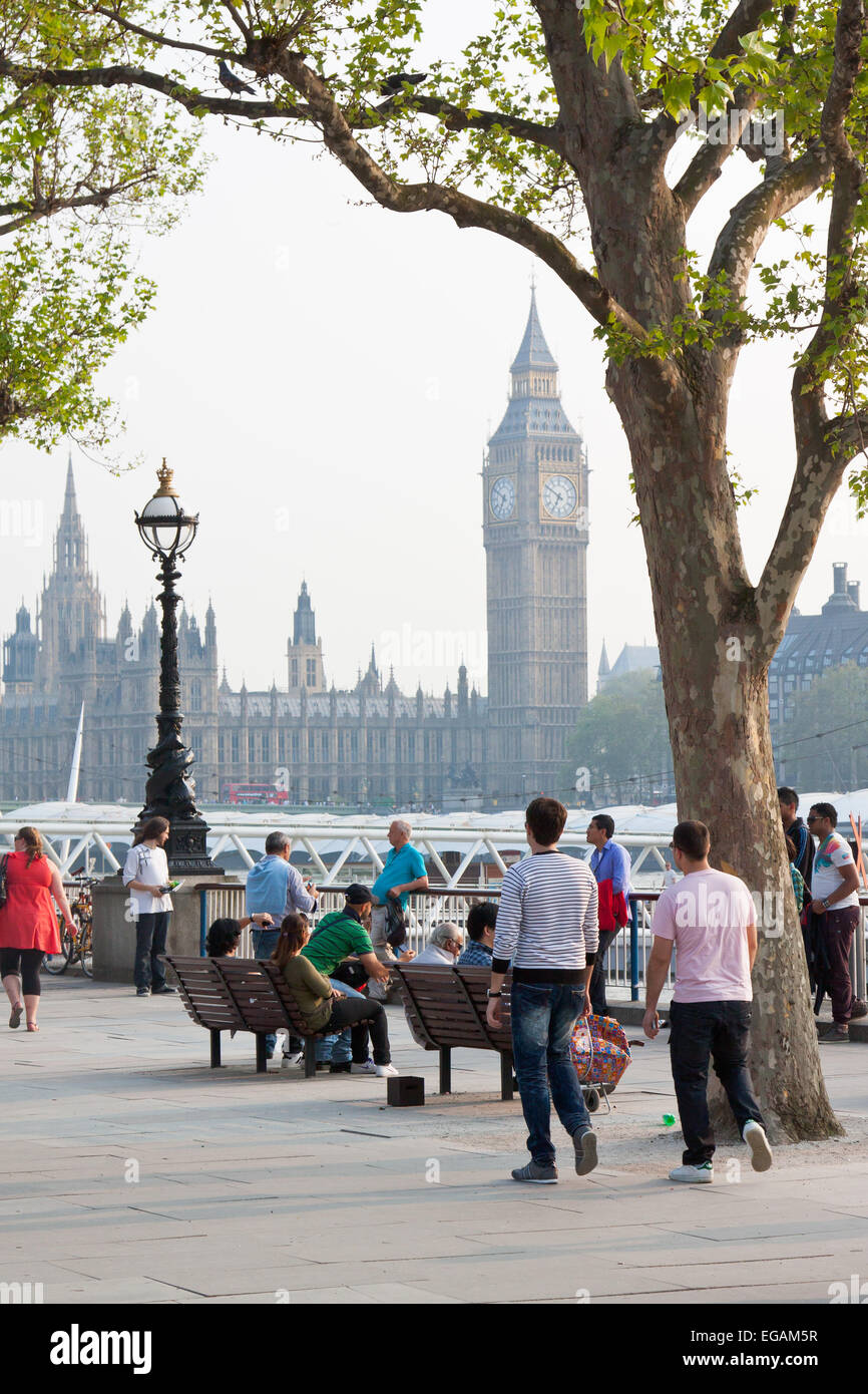 Crowds walking along the Albert Embankment with Big Ben behind, London ...