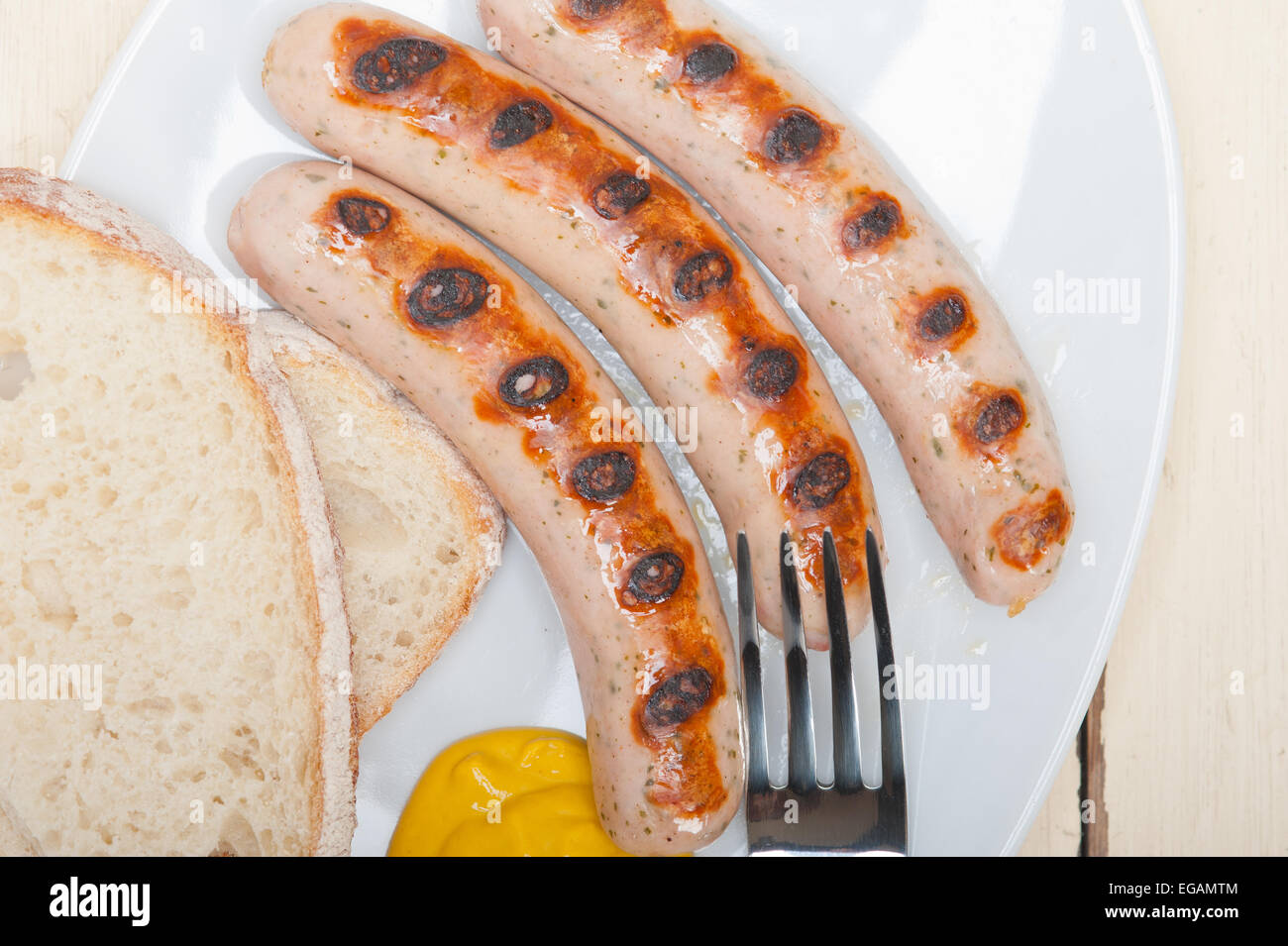 traditional fresh German wurstel sausages grilled with yellow mustard ...