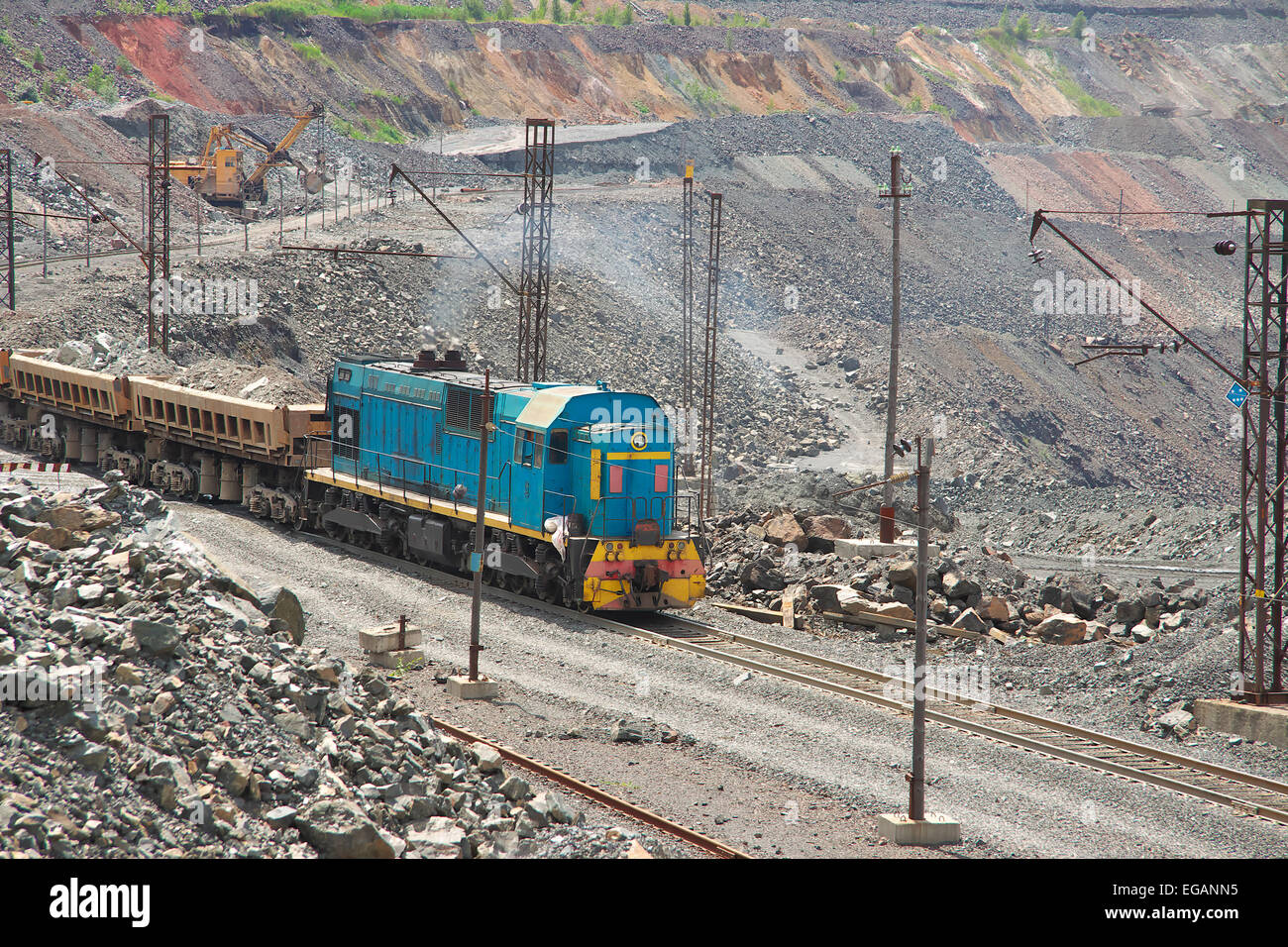 Cargo train carrying iron ore on the opencast mining quarry Stock Photo ...