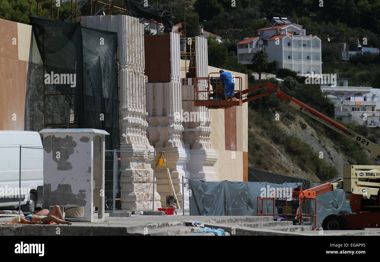 Set builders can be seen piecing together the facade of a pillared ...