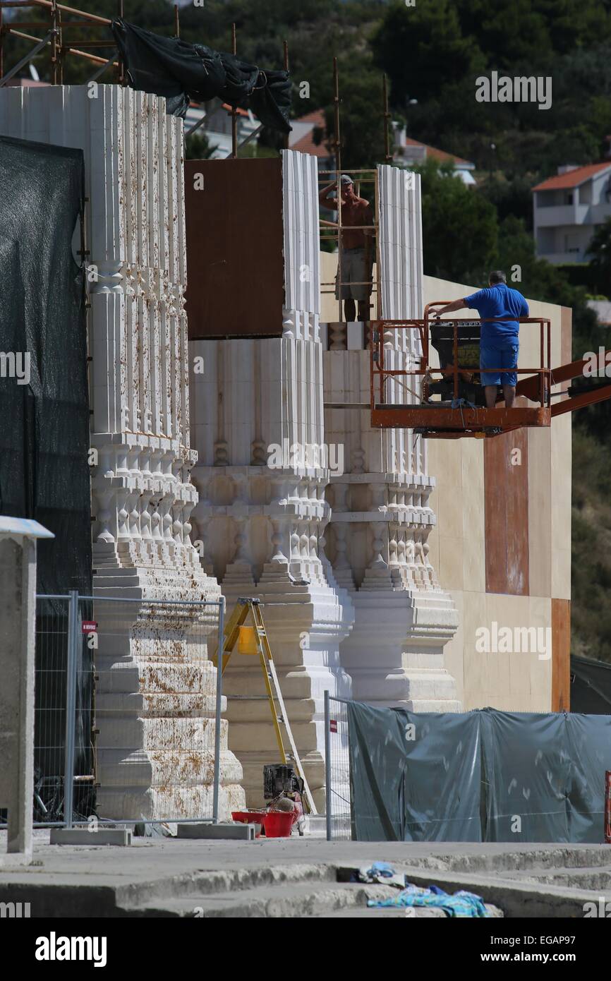 Set builders can be seen piecing together the facade of a pillared ...