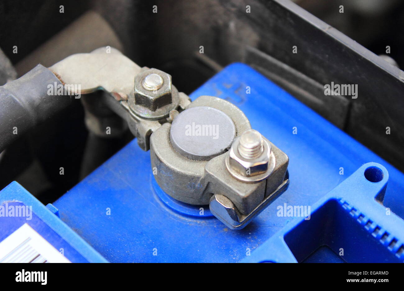 Cables connected to car battery under hood of car Stock Photo - Alamy