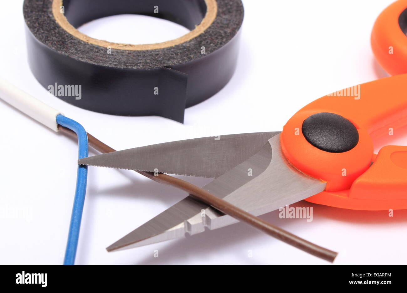Cable cutter, electric wire and black insulating tape on white ...