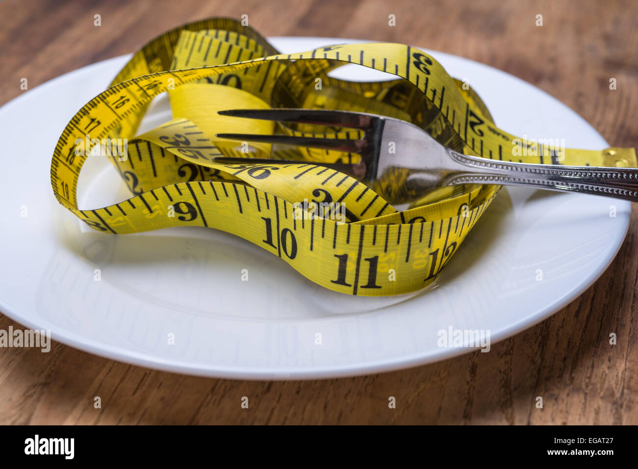 Ruler in a plate on wood table as concept of diet Stock Photo - Alamy