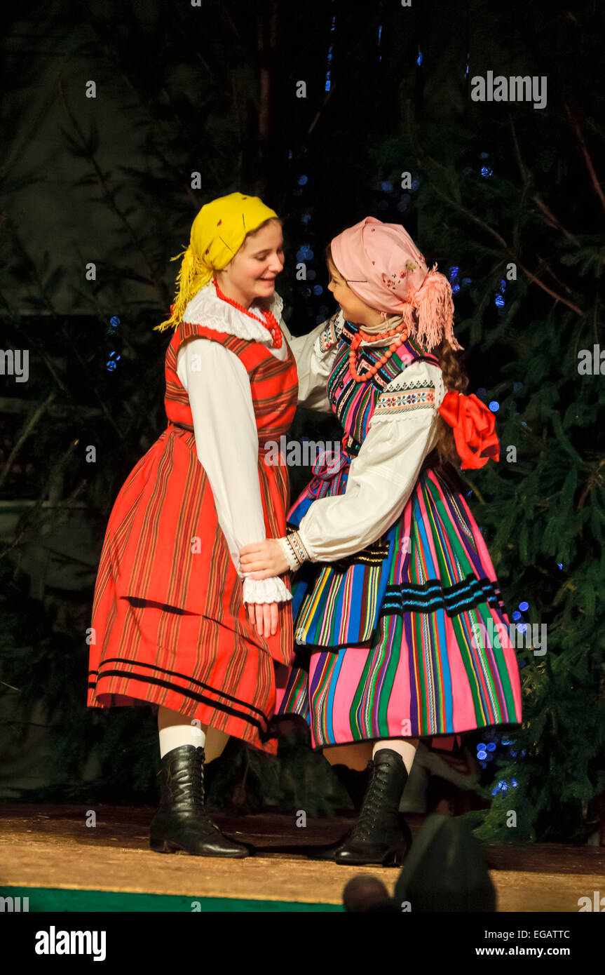 Two women wearing costumes perform a traditional Polish dance Stock ...