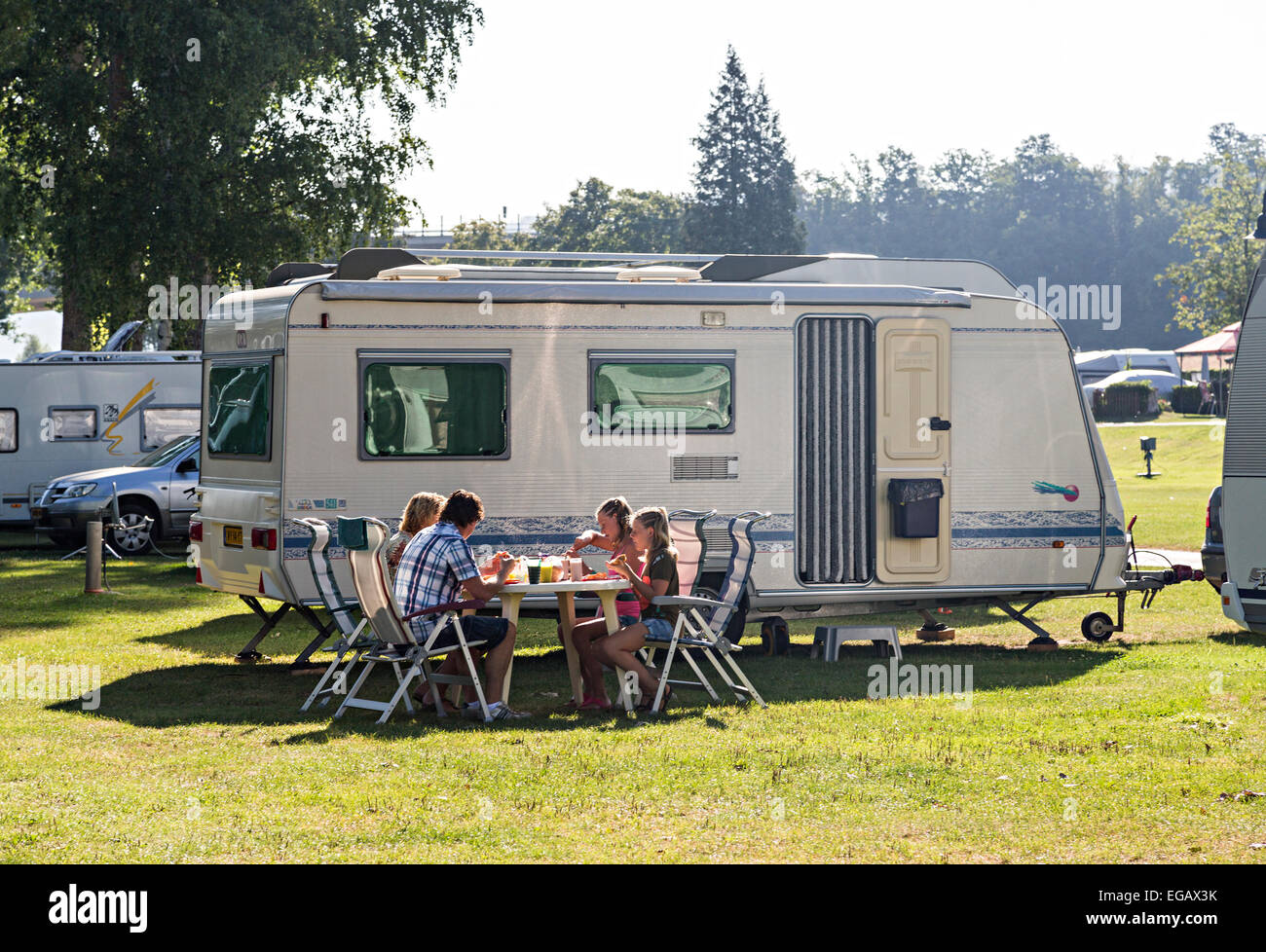Family eating breakfast on campsite at Wertheim-Bettingen, Germany ...