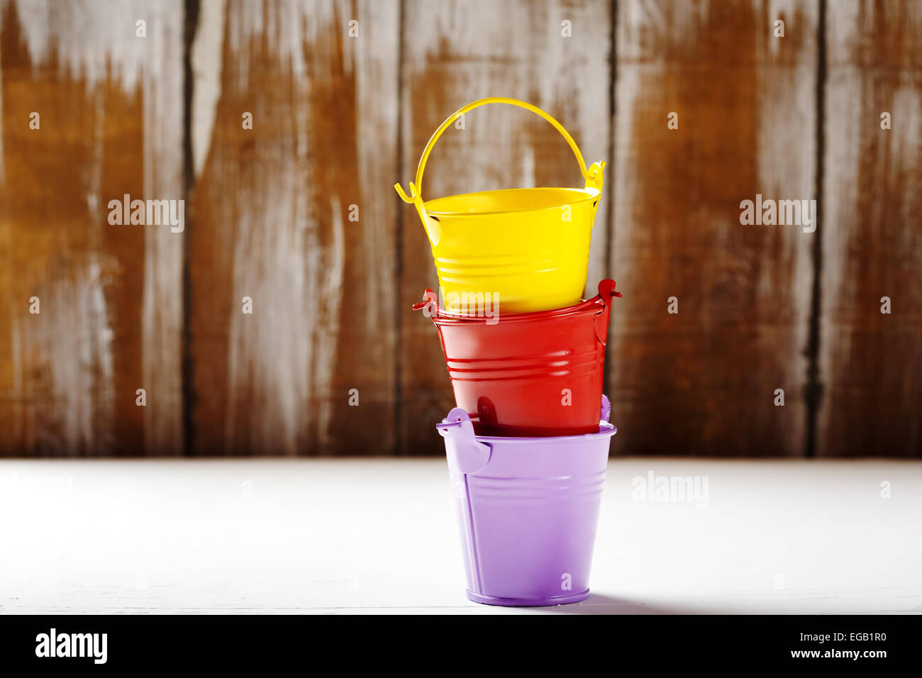 Spring gardening background with cute little colorful garden buckets ...