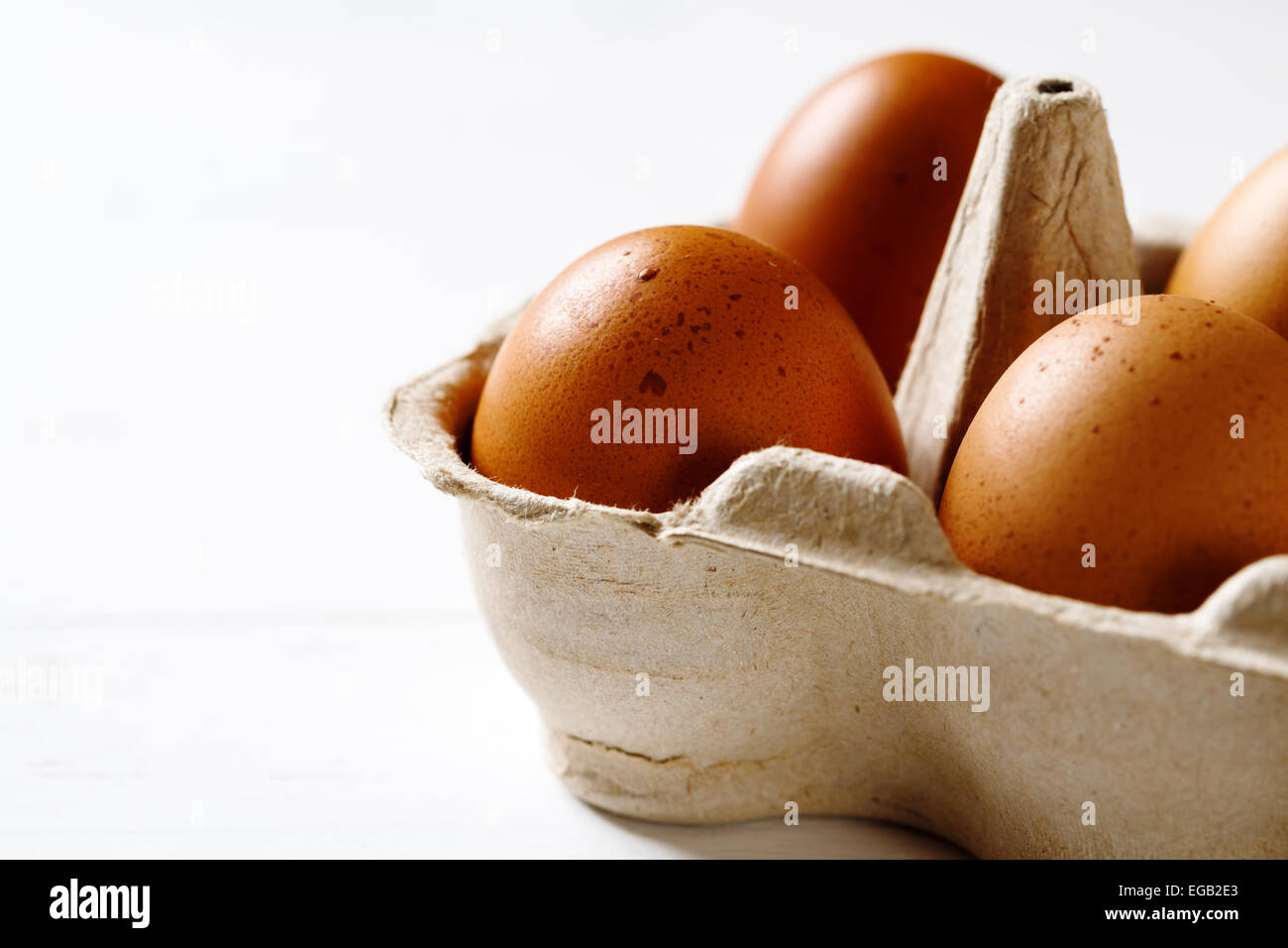 Food background with close up eggs in the package on white Stock Photo ...