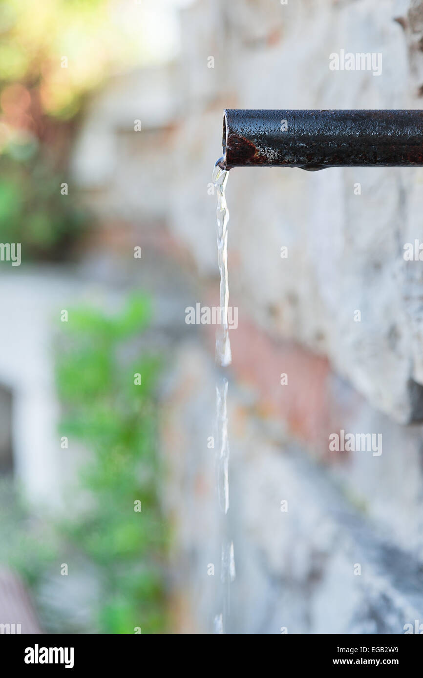 water pipe spring stone Wall Stock Photo - Alamy