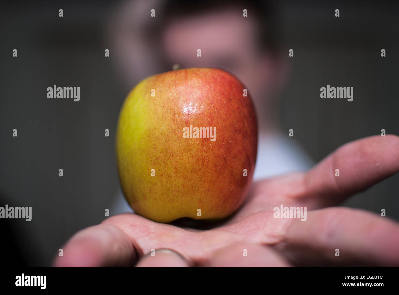 Apple on hand Stock Photo - Alamy
