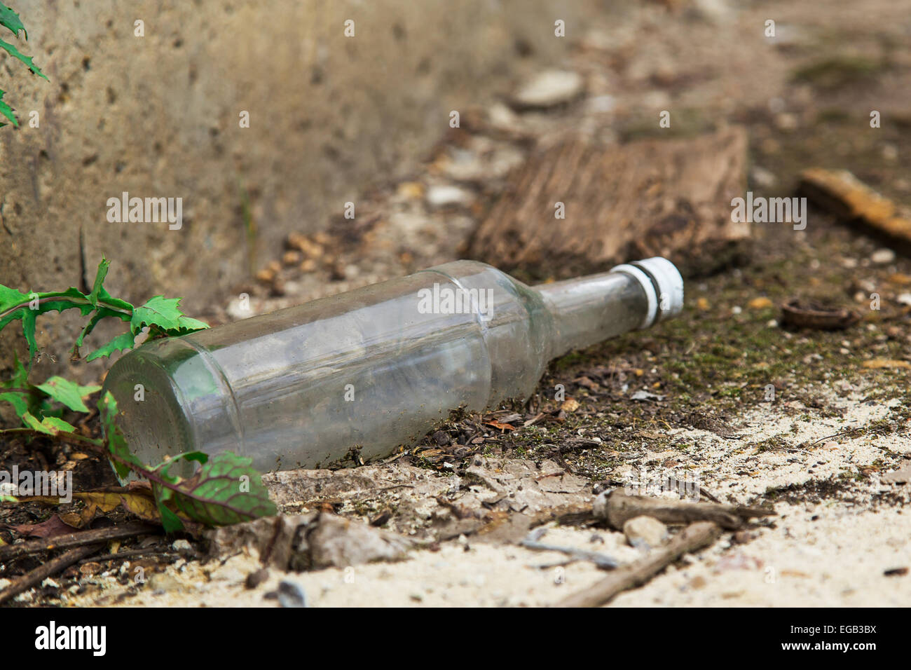 bottle of trash on the ground Stock Photo - Alamy