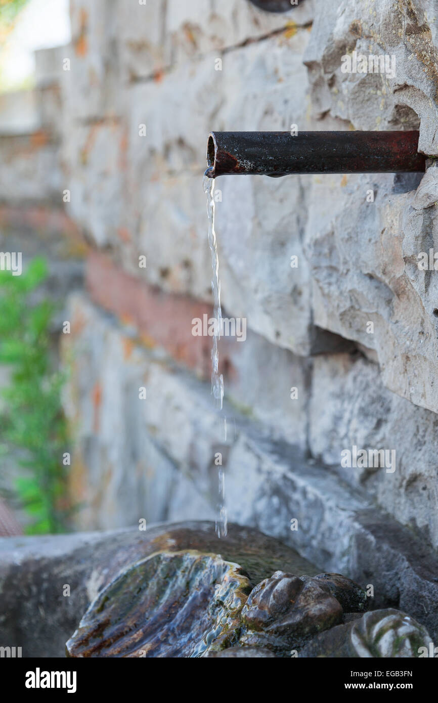 water pipe spring stone Wall Stock Photo - Alamy