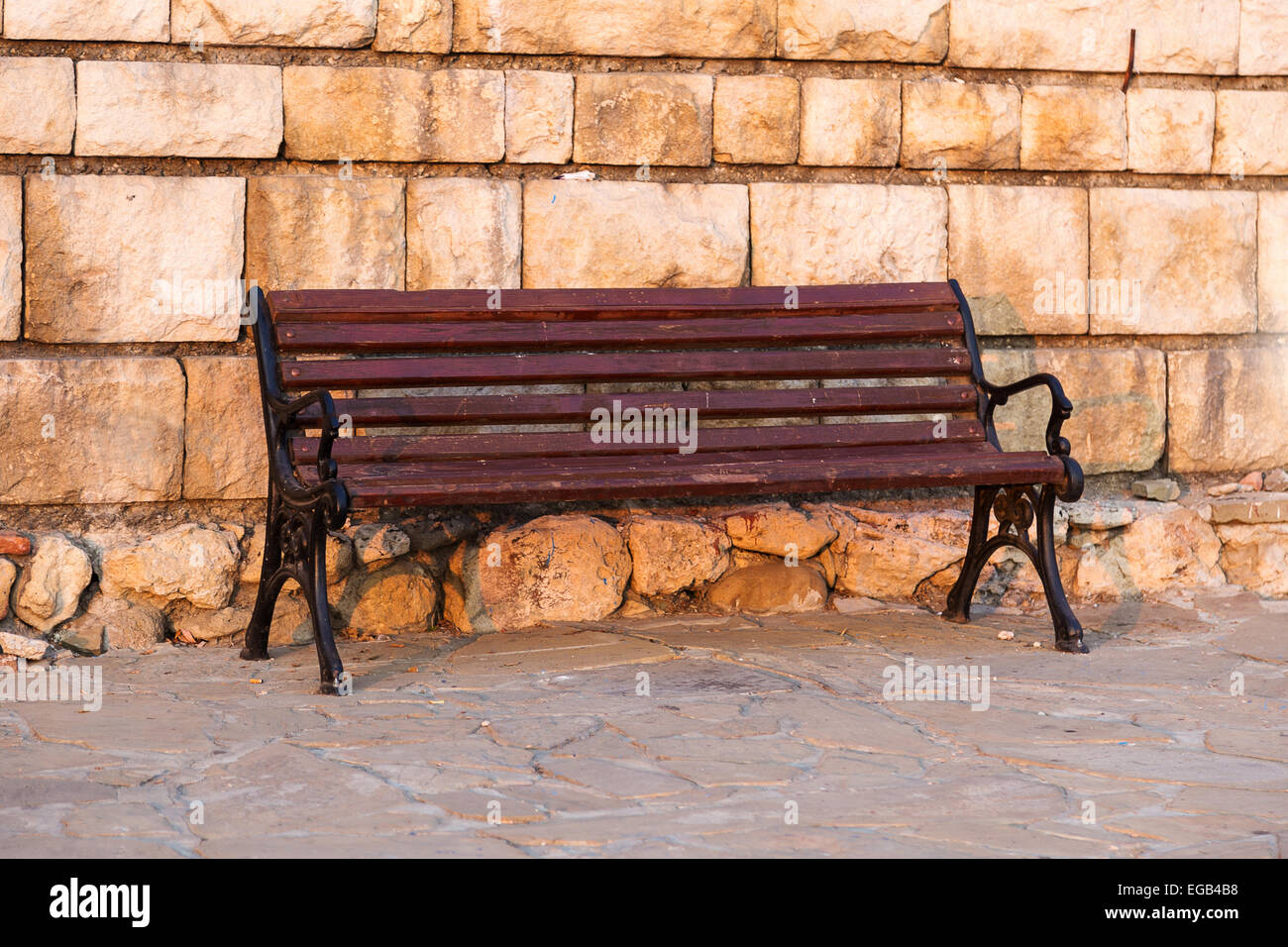 brown bench stone wall background Stock Photo - Alamy