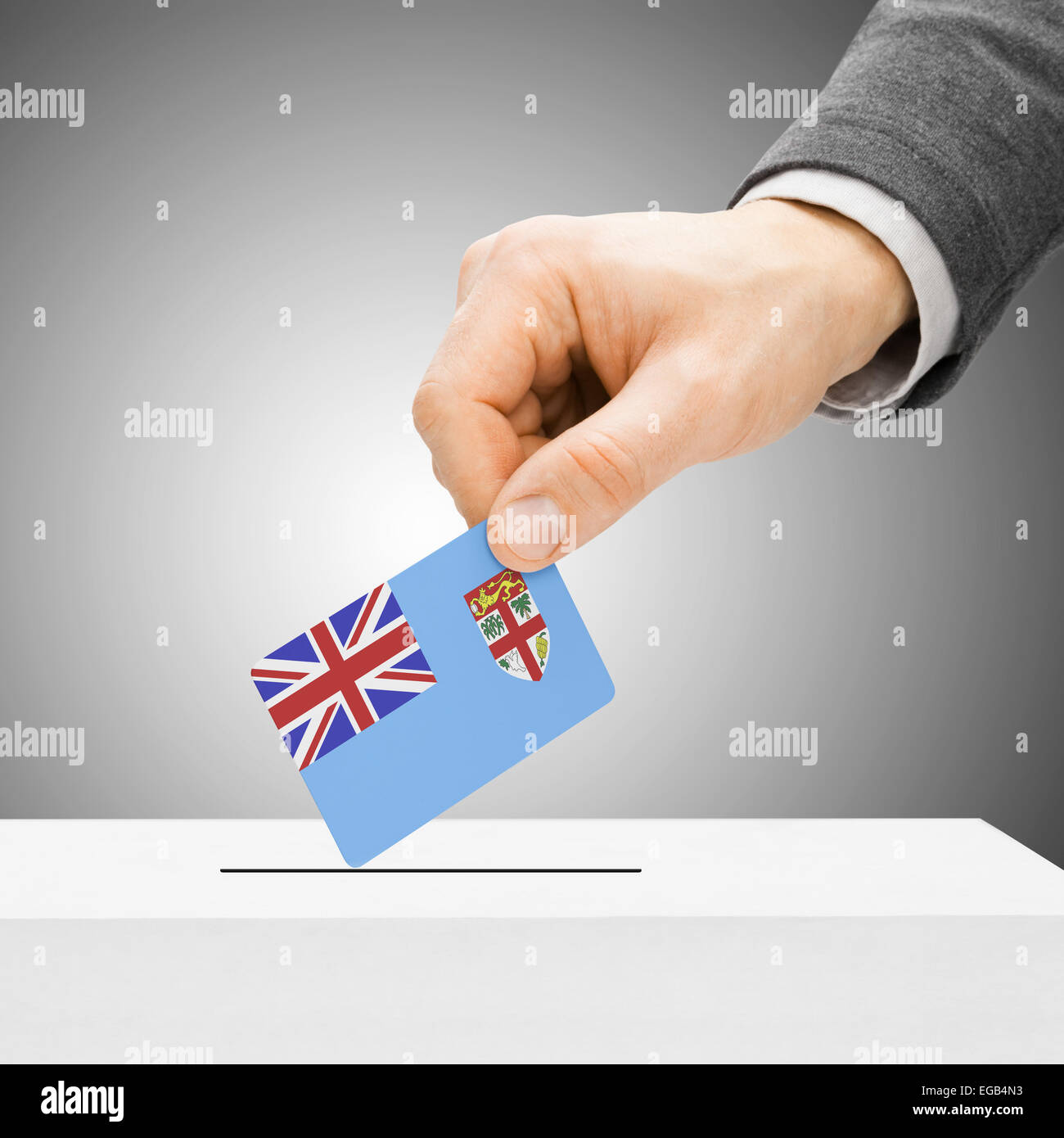 Voting concept - Male inserting flag into ballot box - Fiji Stock Photo ...