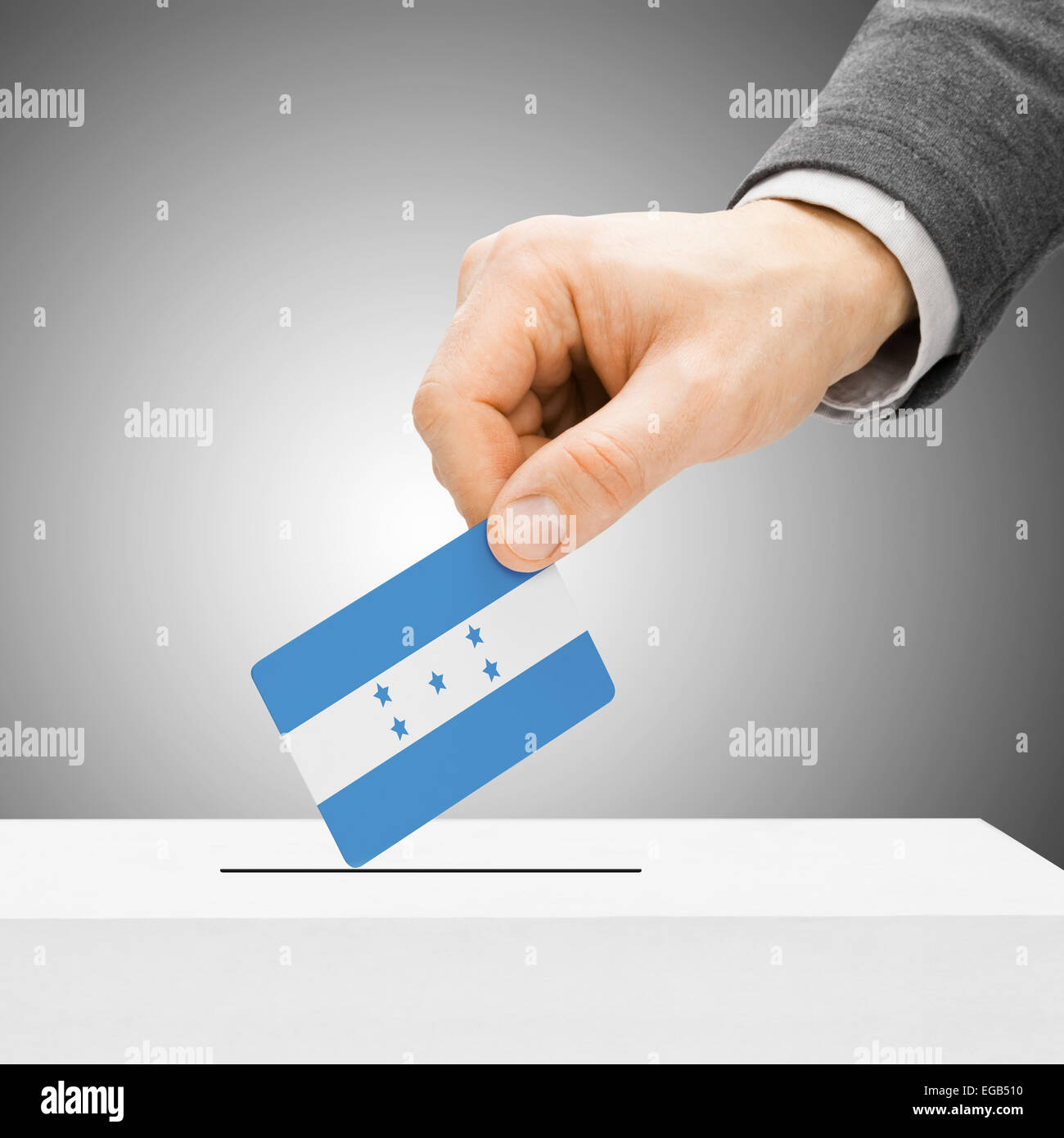 Voting concept - Male inserting flag into ballot box - Honduras Stock ...