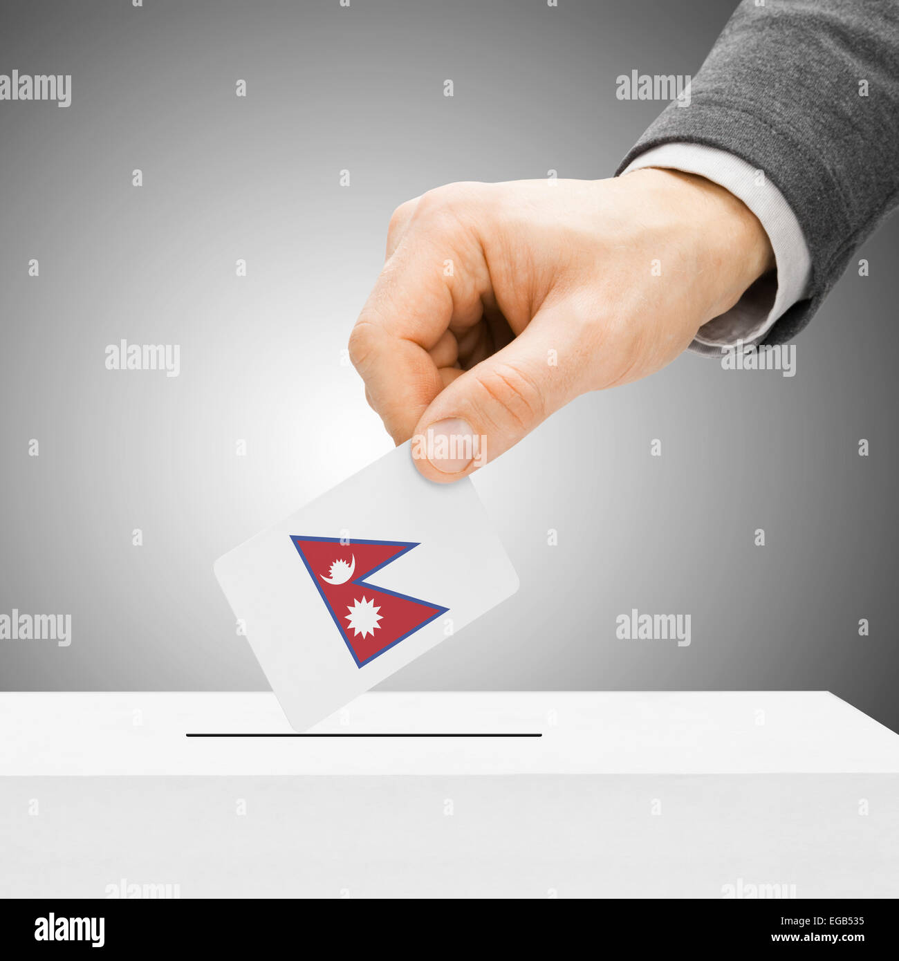 Voting concept - Male inserting flag into ballot box - Nepal Stock ...