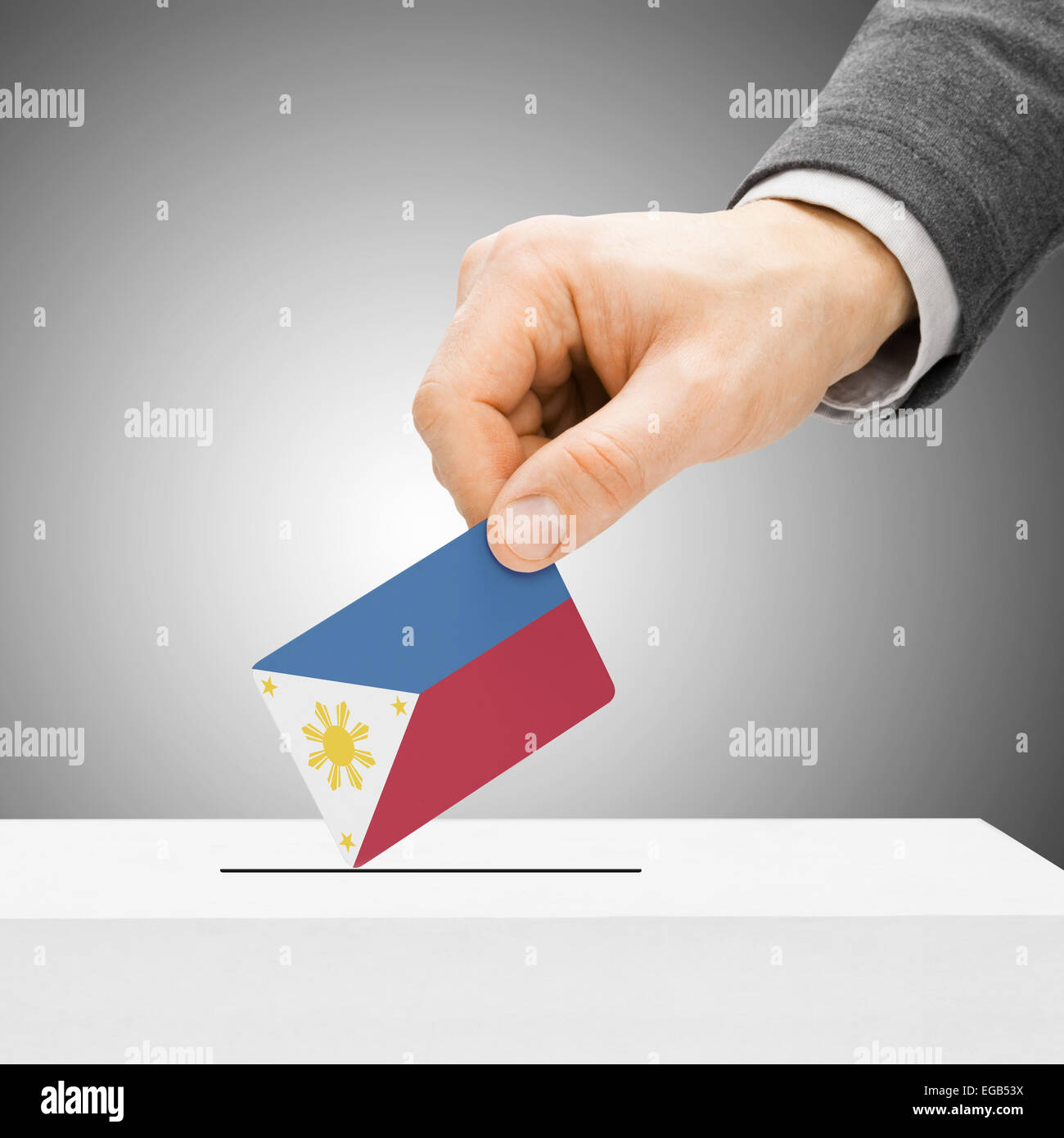 Voting concept - Male inserting flag into ballot box - Philippines ...