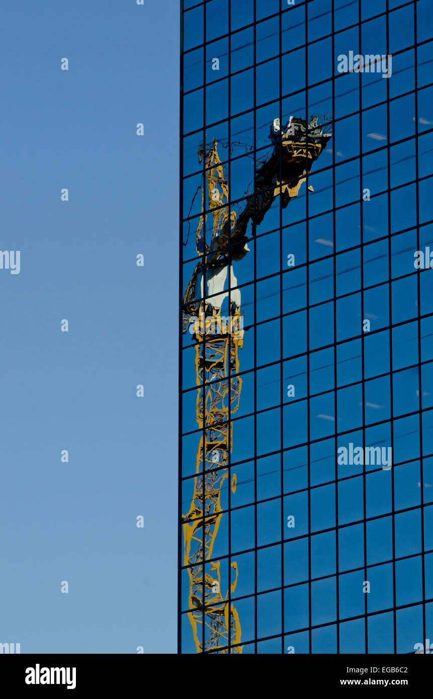 Crane reflection in a building's glass windows Stock Photo - Alamy