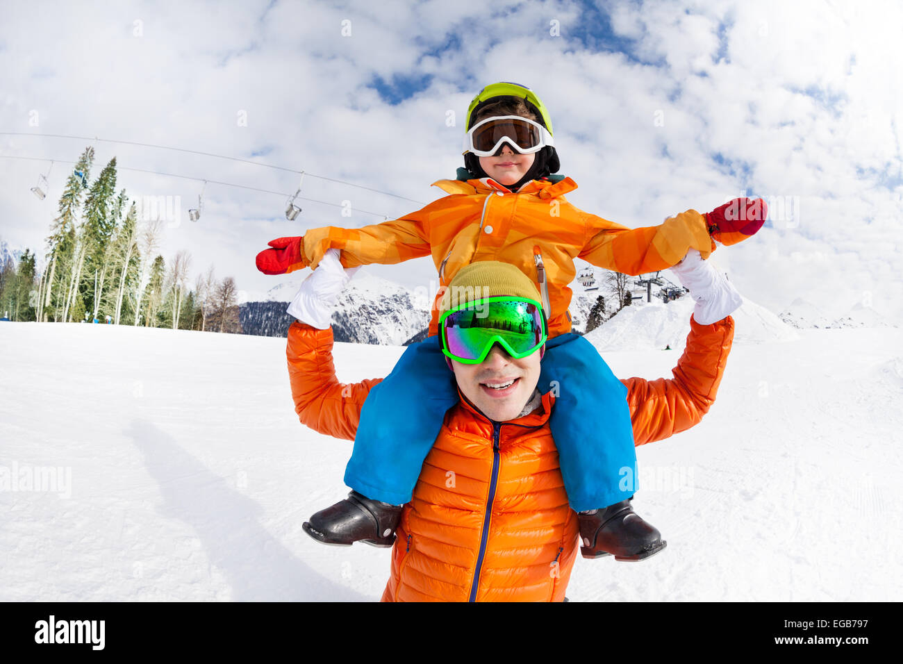 Father and son sitting on shoulders, snow day Stock Photo - Alamy