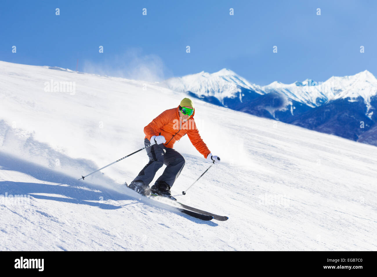 Young man in ski mask sliding fast while skiing Stock Photo - Alamy