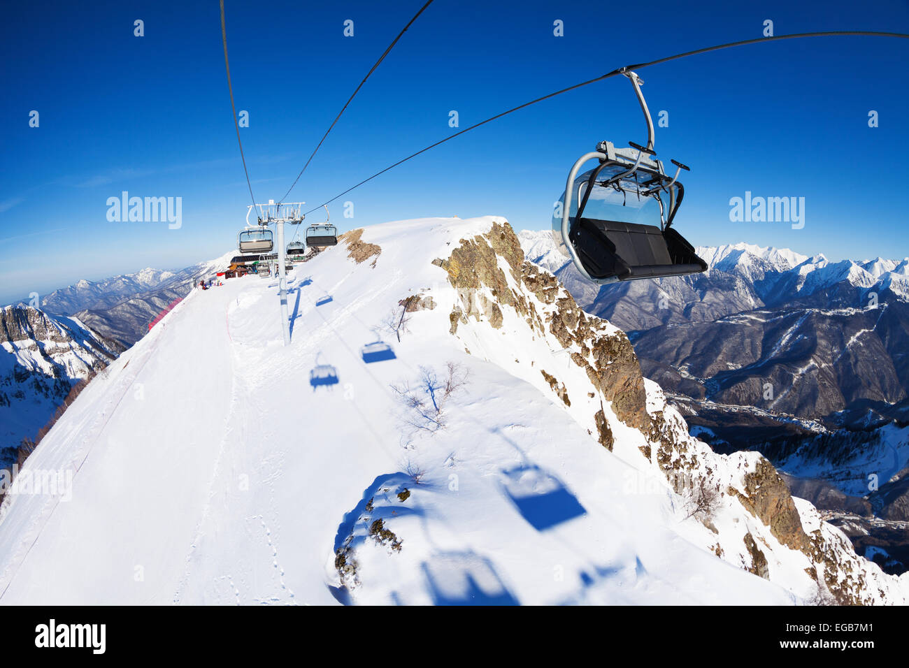 Ski lift with chairs, ropeway over mountain range Stock Photo - Alamy