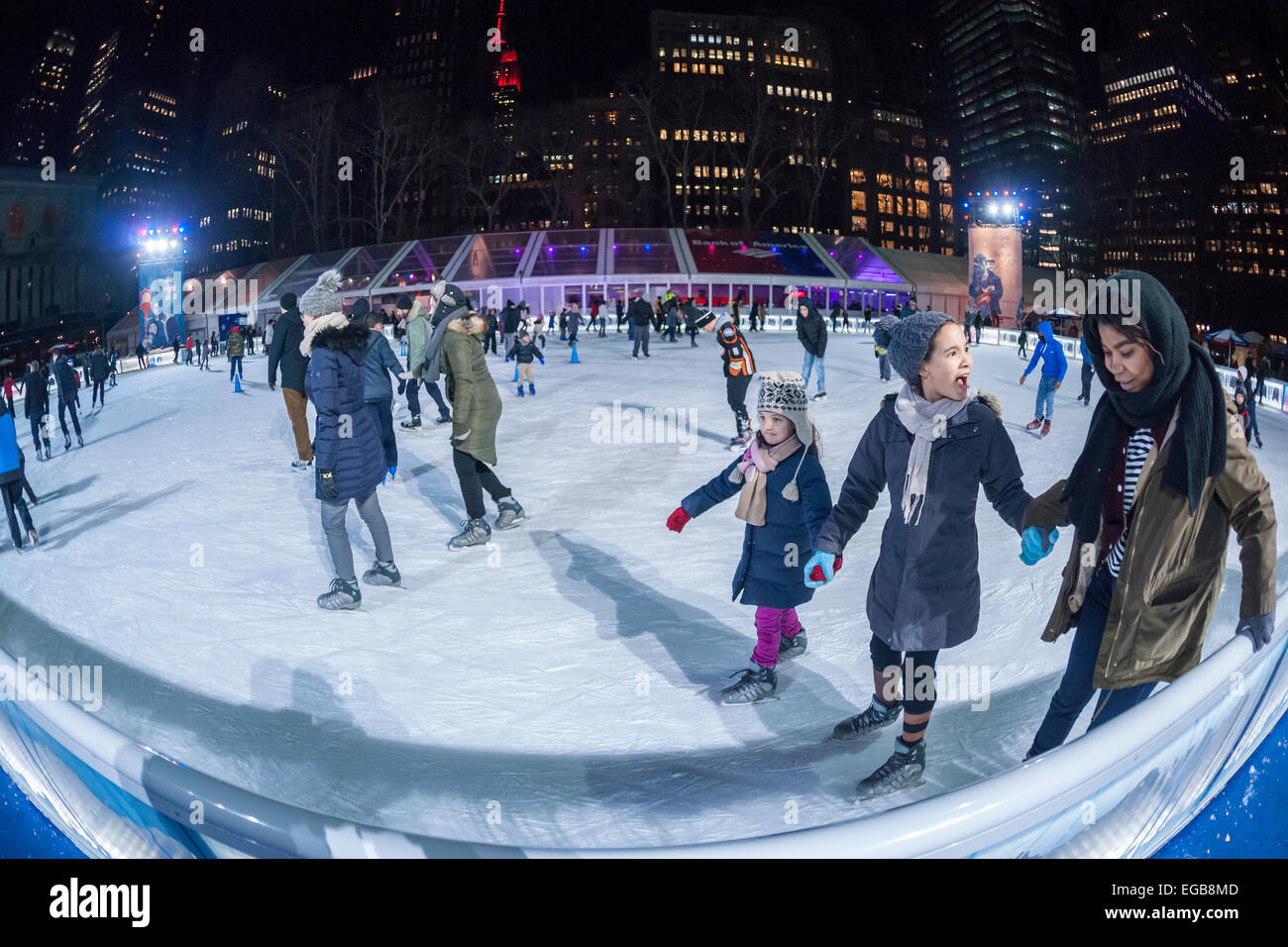 Skaters maneuver the packed Winter Village ice skating rink at Bryant ...
