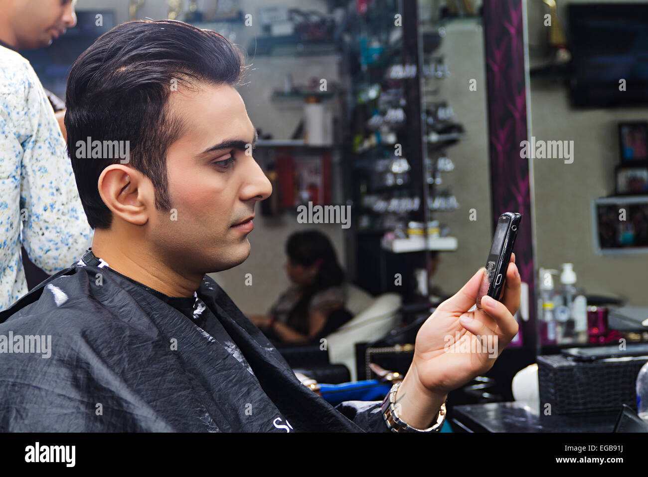1 indian man Saloon Dialing phone Stock Photo - Alamy