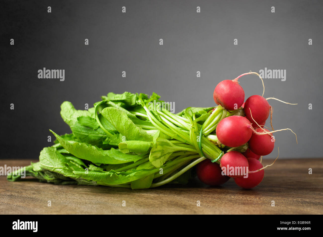 Red radishes on dark wood hi-res stock photography and images - Alamy