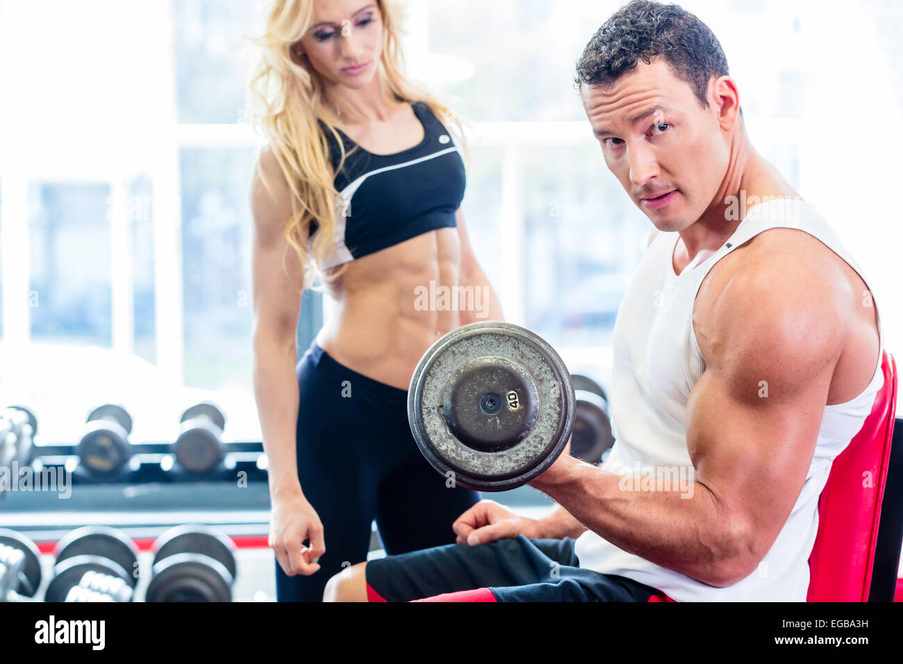Couple in fitness gym with dumbbells lifting weight as sport, man and ...