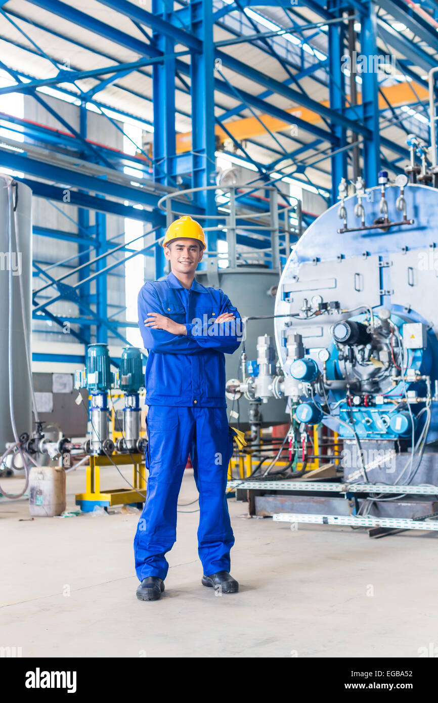 Proud Asian worker standing in production factory Stock Photo - Alamy
