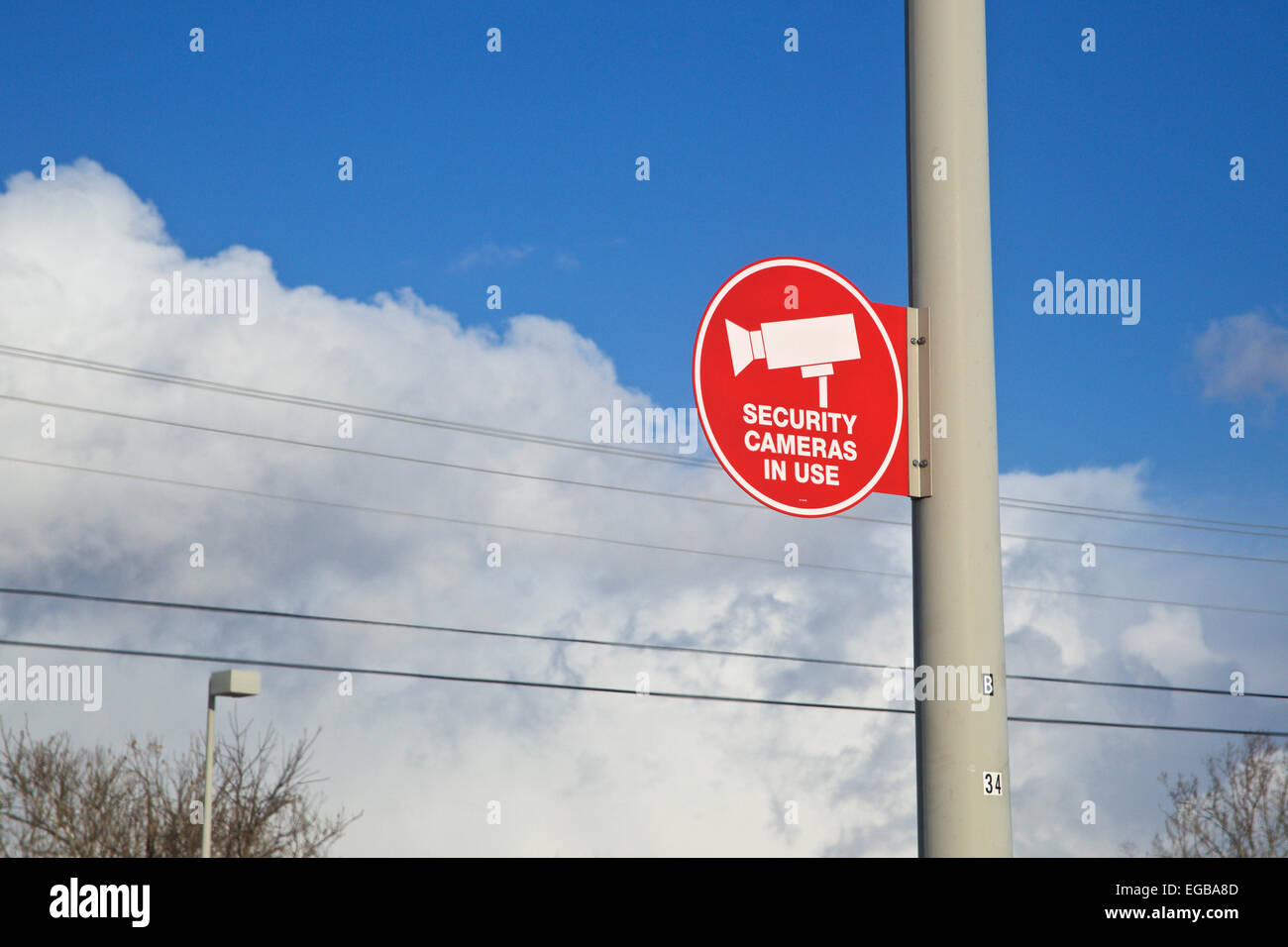 Security cameras in use sign in store parking lot warning people Stock ...