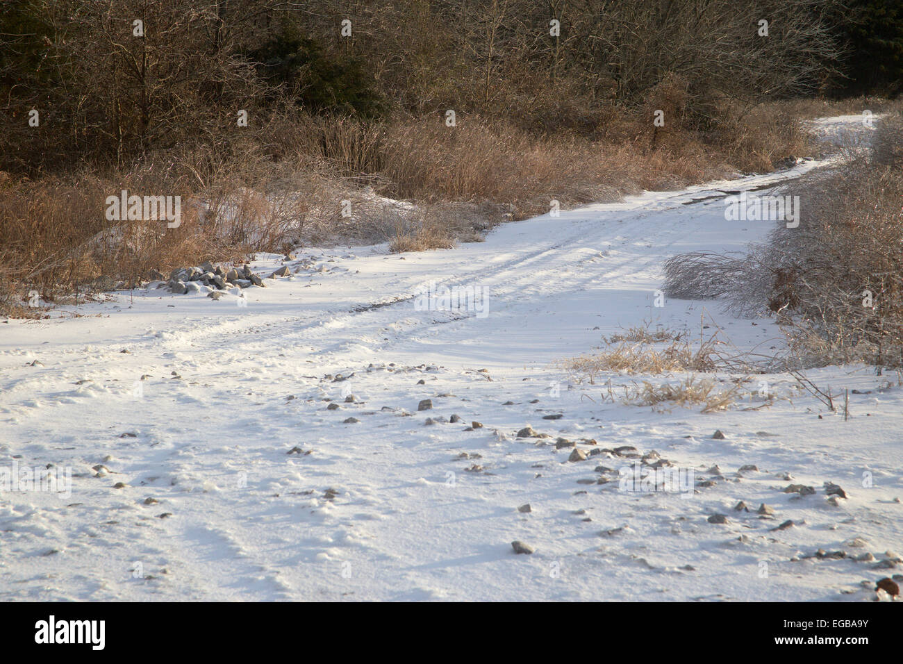 Snowy entrance to a rural road Stock Photo - Alamy