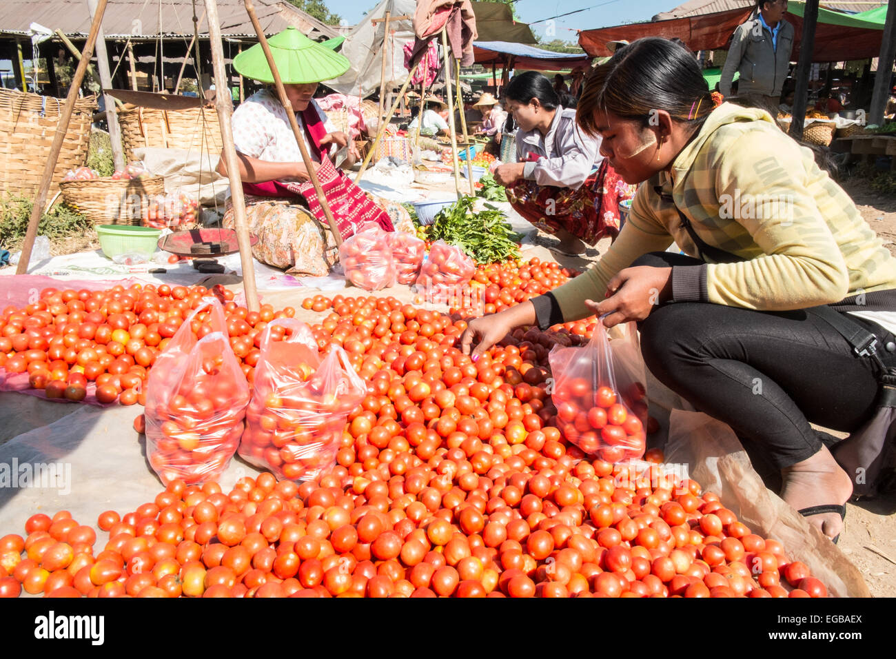 Locals at 5 Day Market, a rotating system,on banks of Inle Lake. Here ...