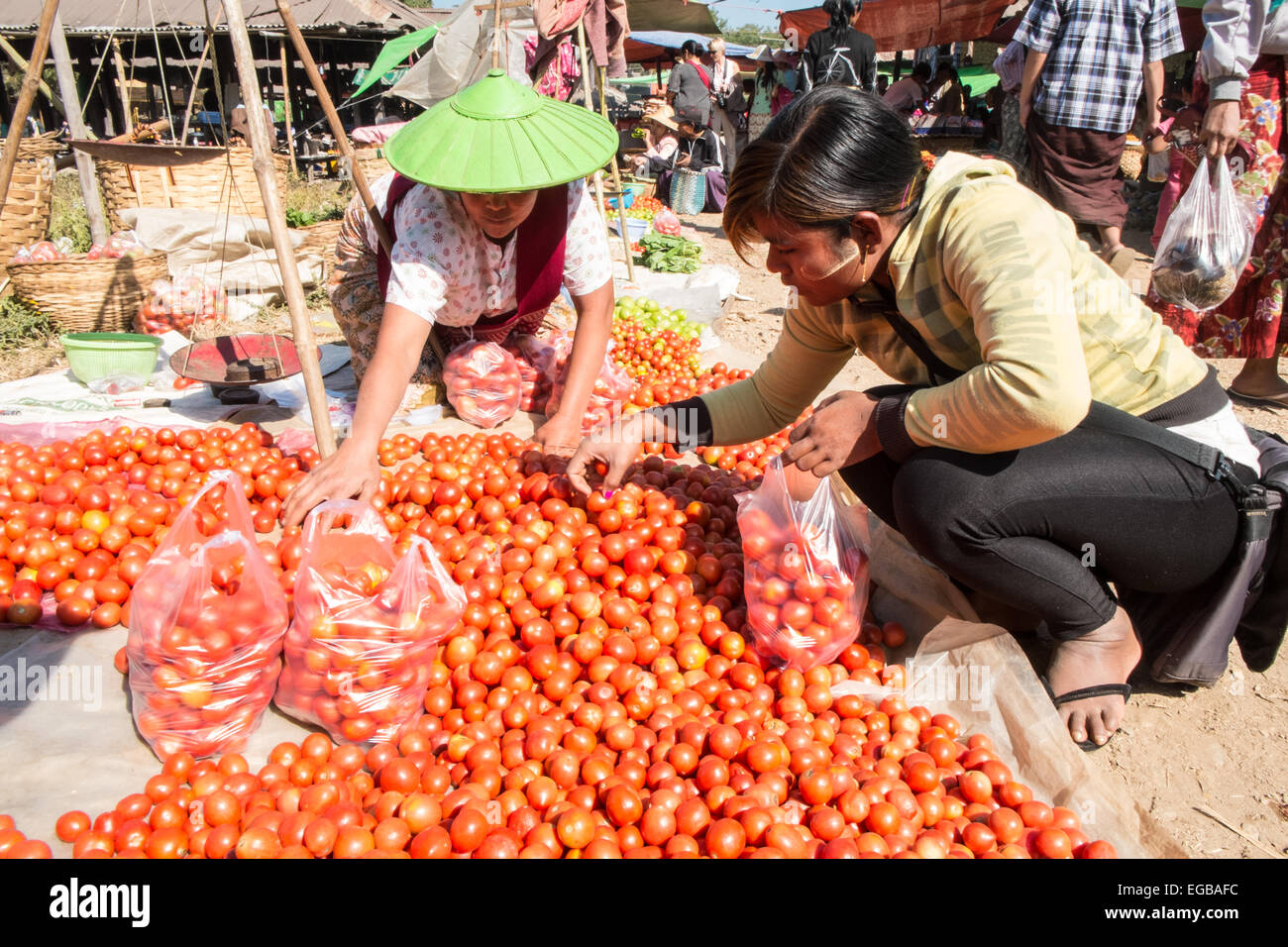 Locals at 5 Day Market, a rotating system,on banks of Inle Lake. Here ...