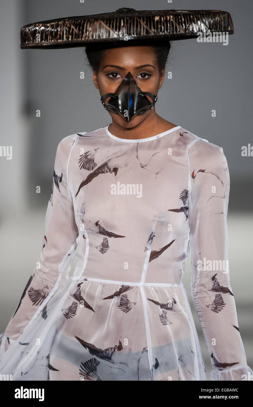 London, UK. 21st February, 2015. A model wears an elaborate hat and ...