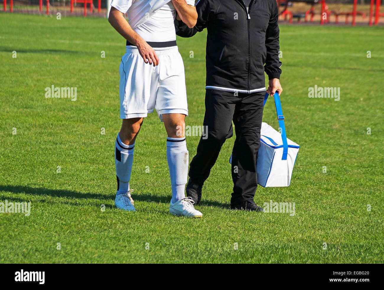 Medic helps the injured soccer player Stock Photo - Alamy
