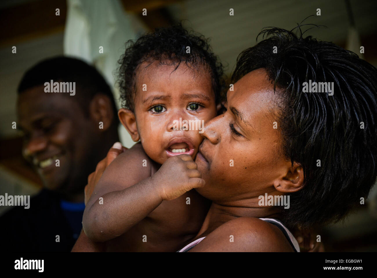 Solevu Village, Malolo Islands, Fiji. 3rd Feb, 2015. A mother kisses ...